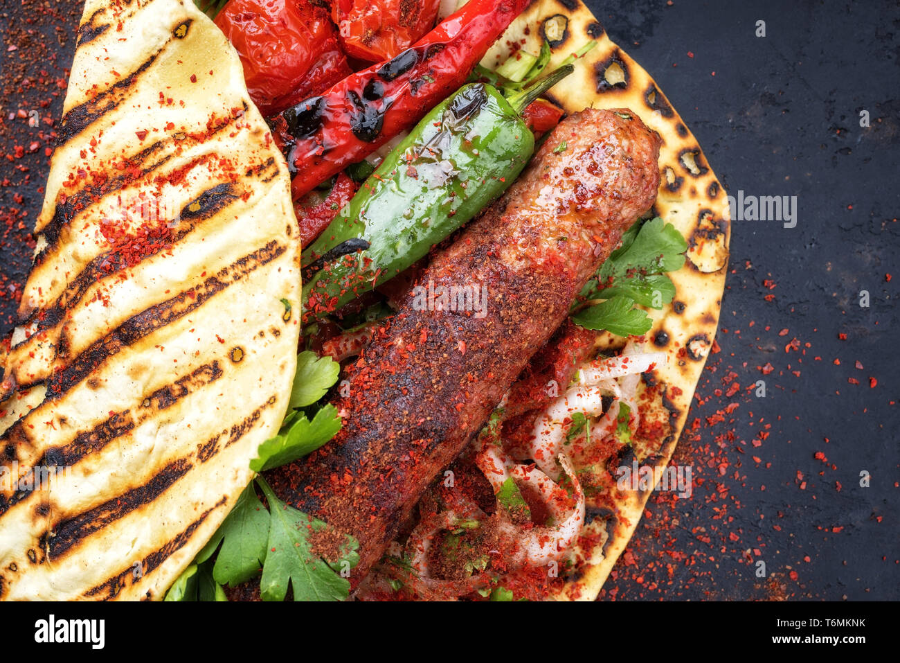 Traditional Adana Kebap with tomato and salad on a flatbread with copy ...