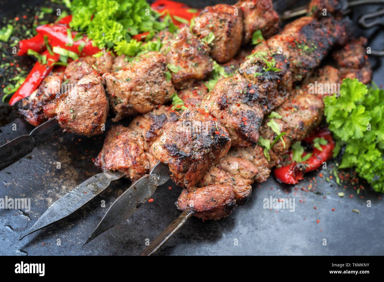 Traditional Russian shashlik on a barbecue skewer with paprika as ...