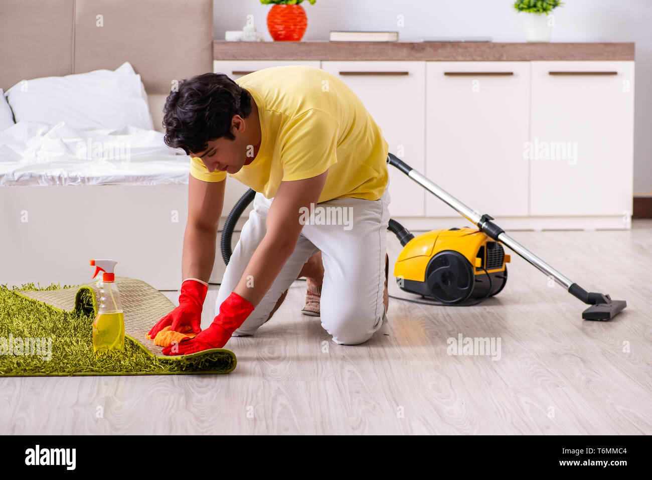 Man vacuuming bed hi-res stock photography and images - Alamy