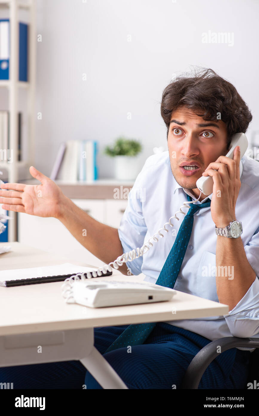 Overloaded busy employee with too much work and paperwork Stock Photo ...