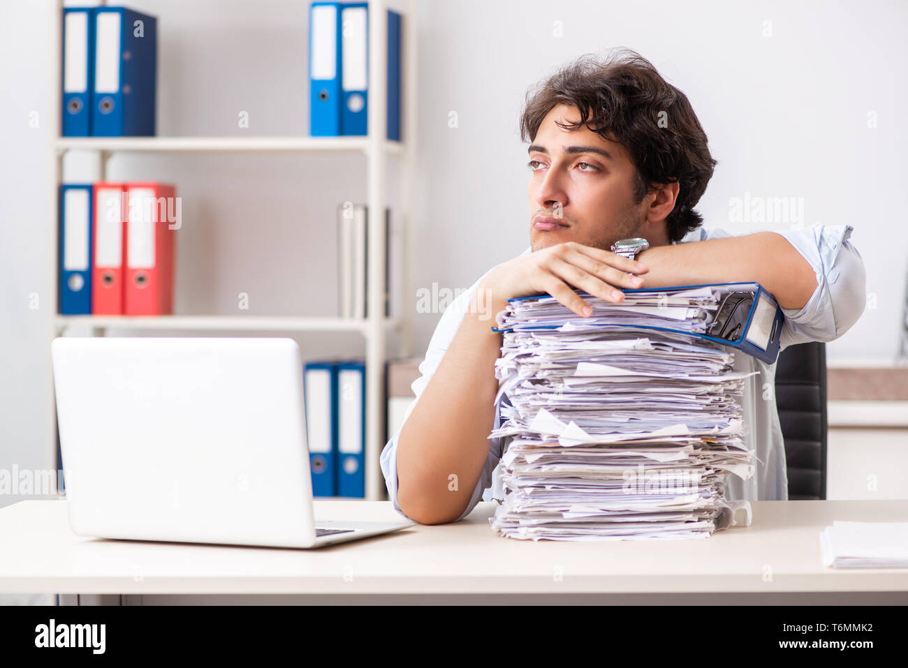 Overloaded busy employee with too much work and paperwork Stock Photo ...