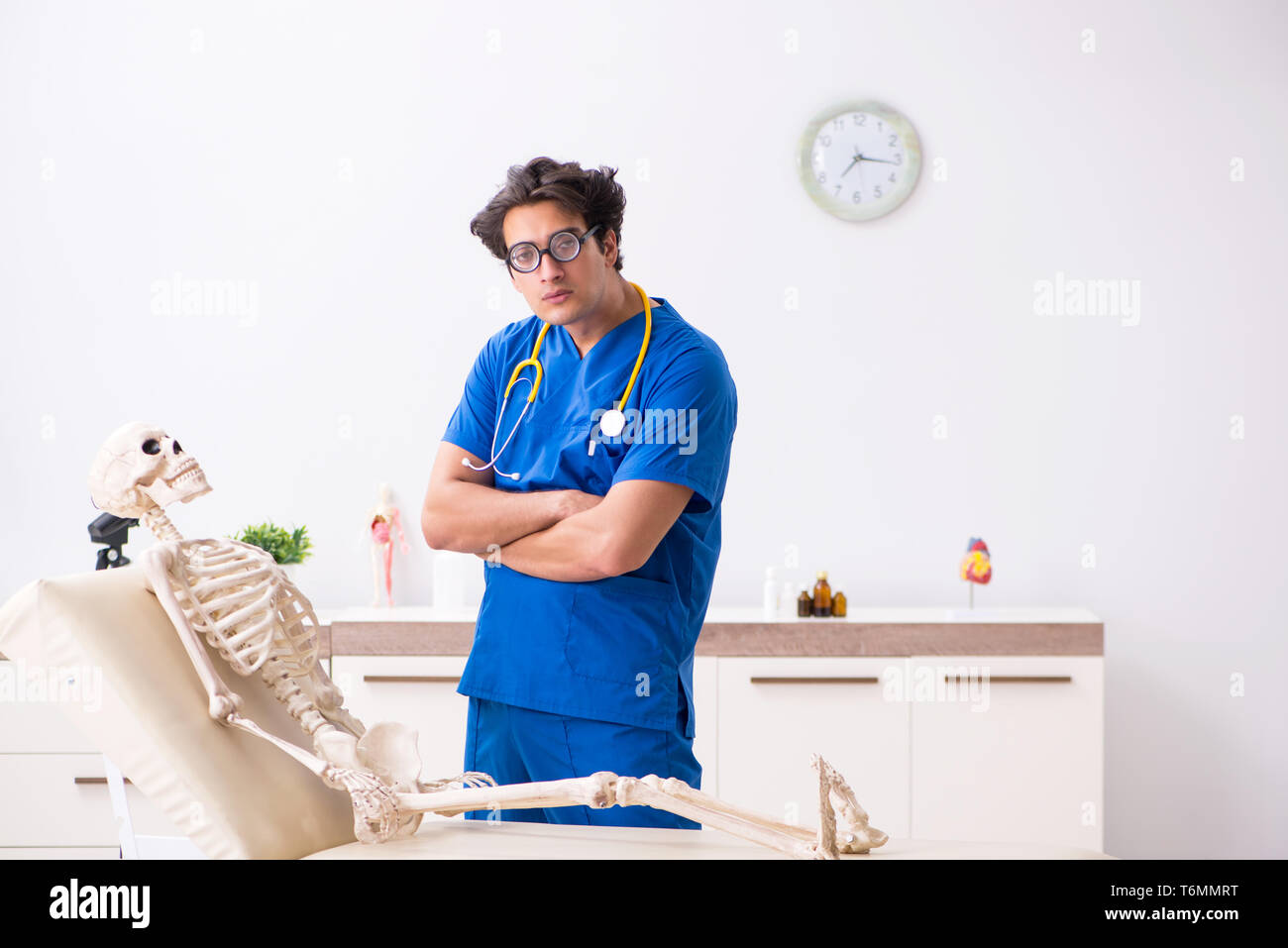 Funny doctor with skeleton in hospital Stock Photo - Alamy