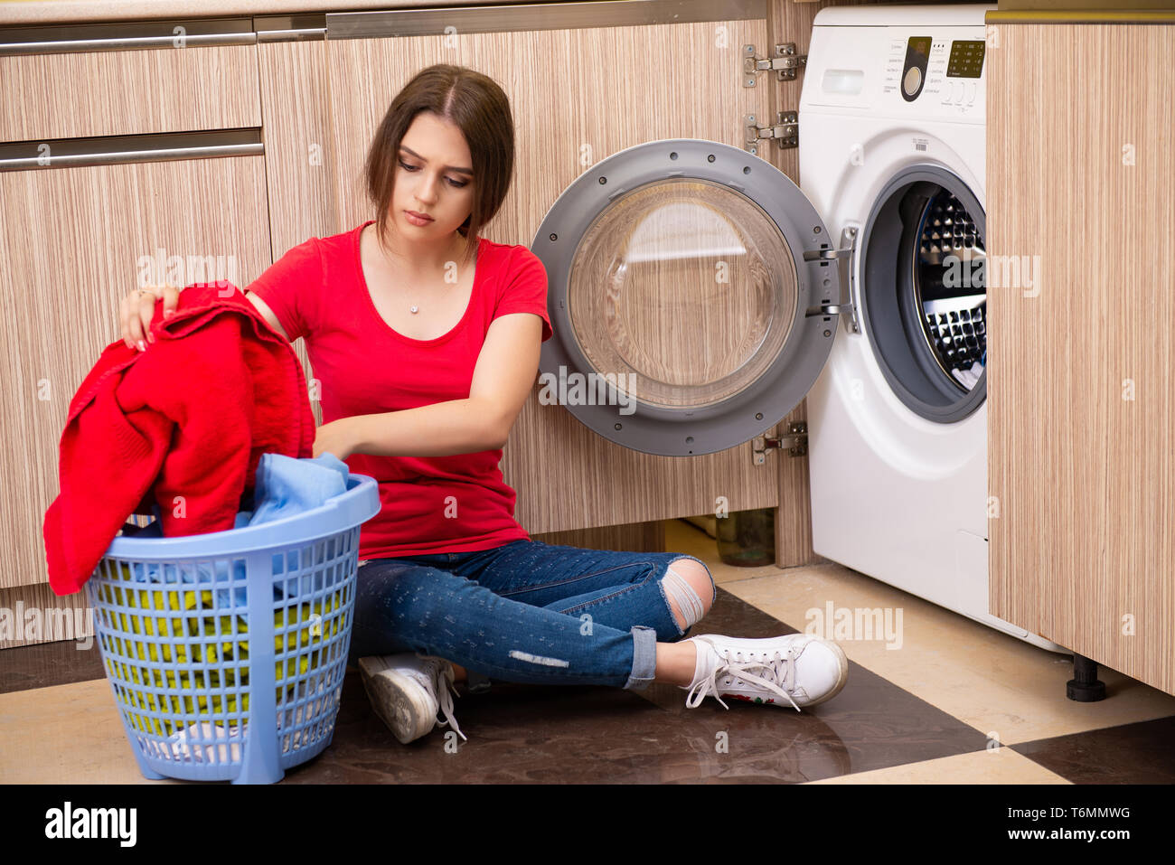 Woman doing laundry at home Stock Photo - Alamy