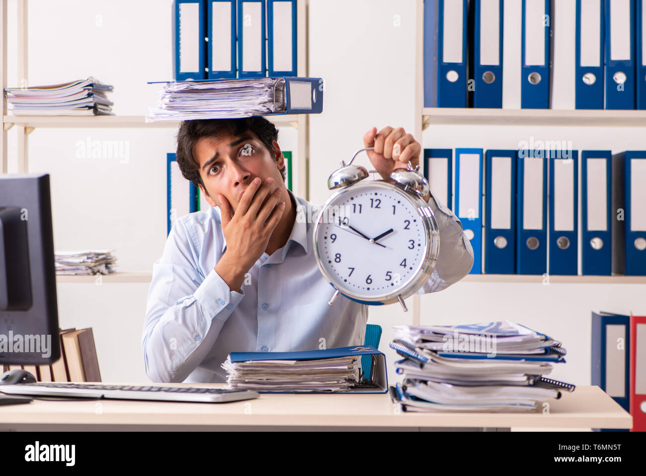 Overloaded busy employee with too much work and paperwork Stock Photo ...
