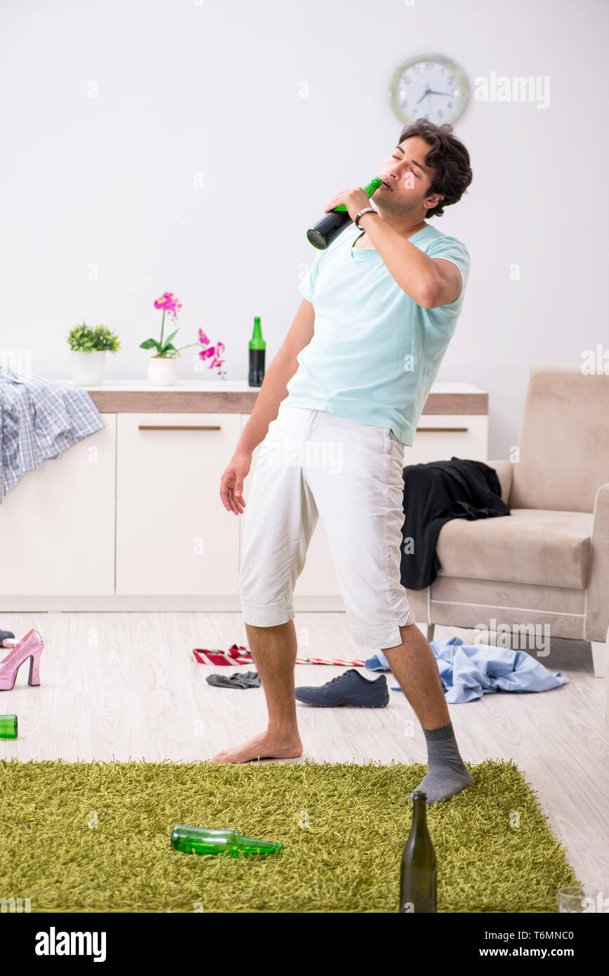 Young drunk handsome man after party at home Stock Photo - Alamy