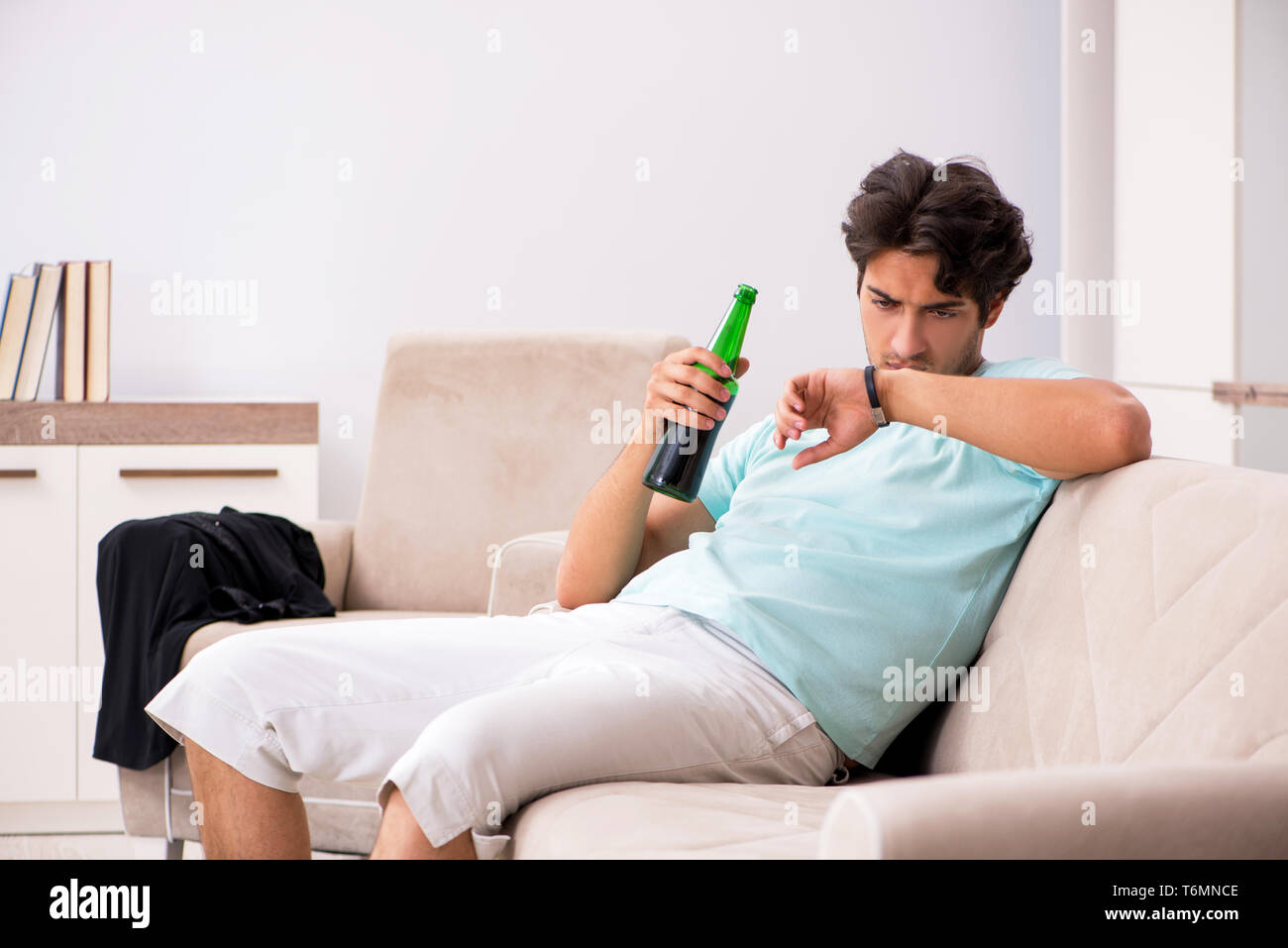Young drunk handsome man after party at home Stock Photo - Alamy