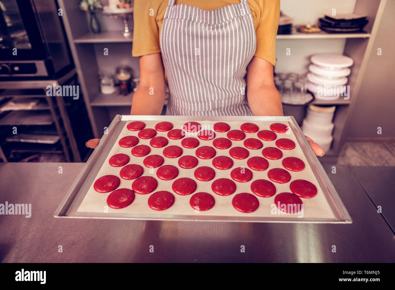Strong female person holding tray in both hands Stock Photo - Alamy