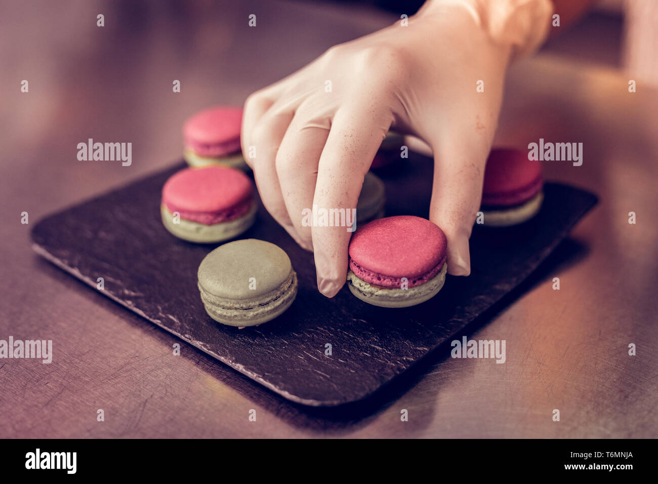 Female hand wearing gloves during delicate work Stock Photo - Alamy