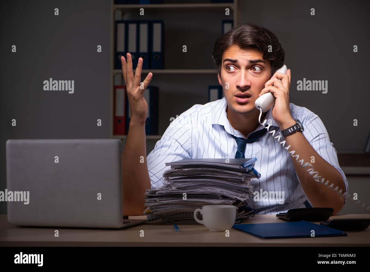 Young financial manager working late at night in office Stock Photo - Alamy