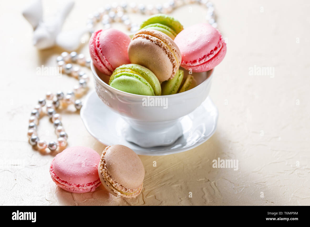 Colourful macaroons on the plates Stock Photo - Alamy