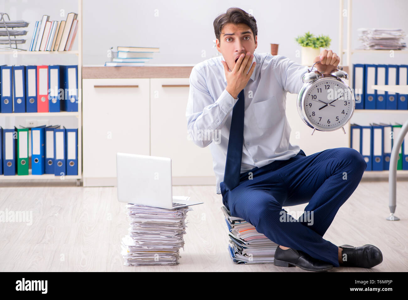 Extremely busy employee working in the office Stock Photo - Alamy