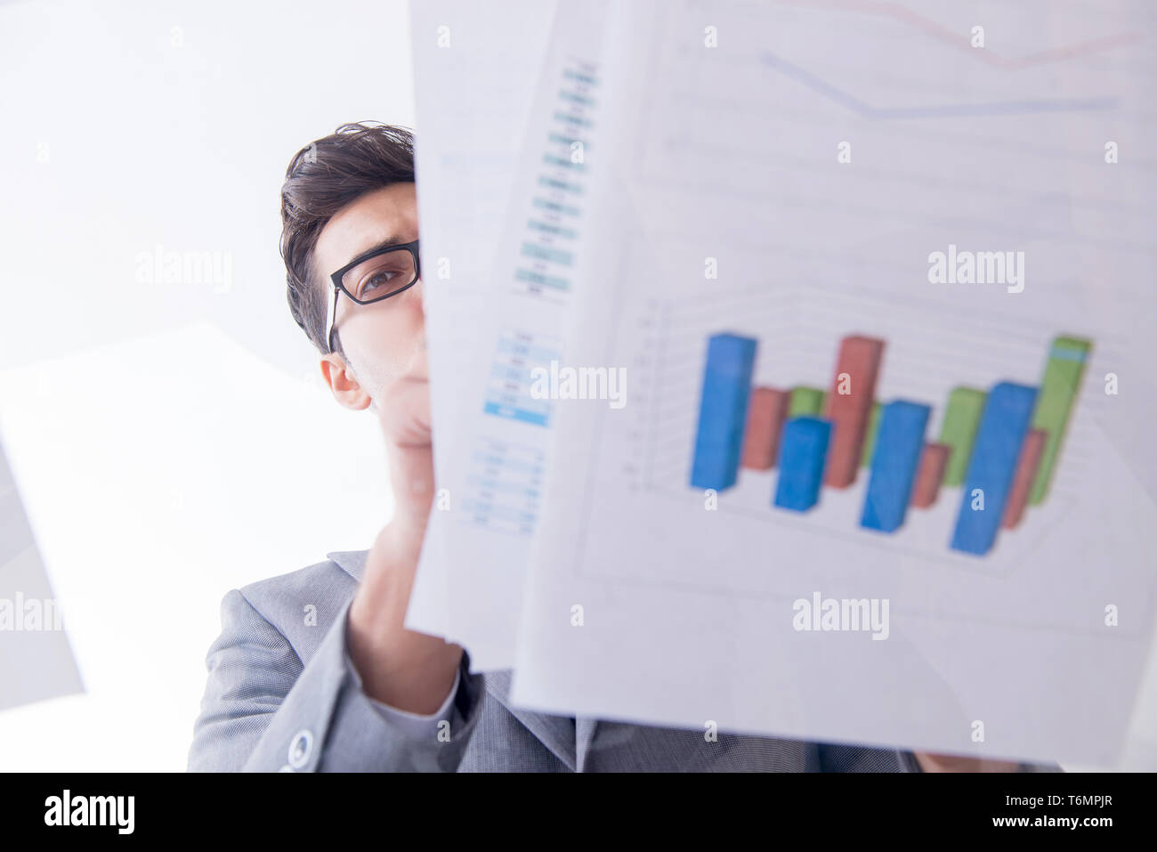 Businessman looking at financial charts and graphs Stock Photo - Alamy