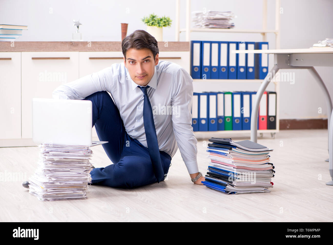 Extremely busy employee working in the office Stock Photo - Alamy
