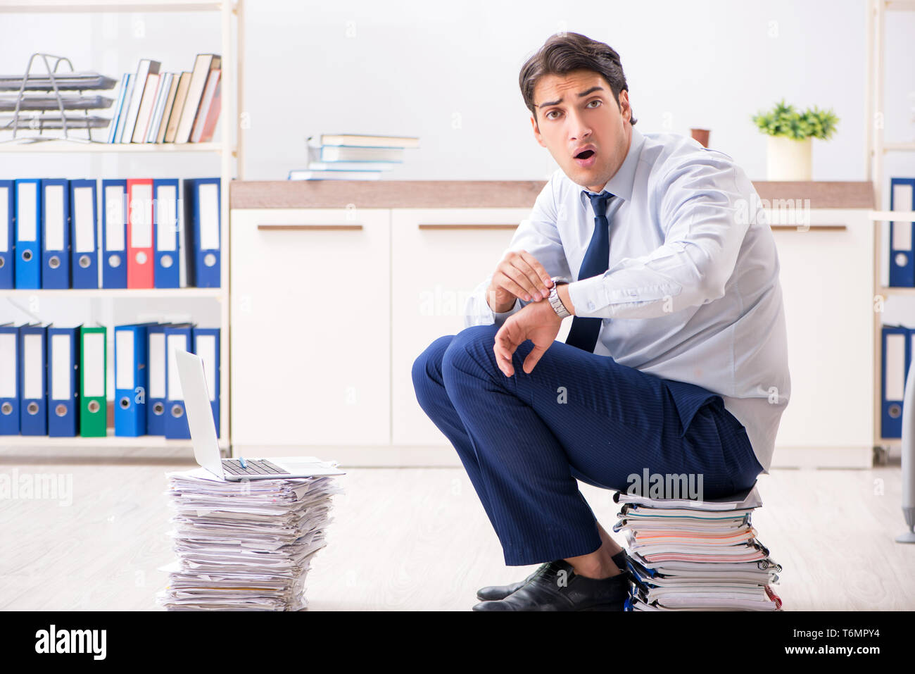 Extremely busy employee working in the office Stock Photo - Alamy