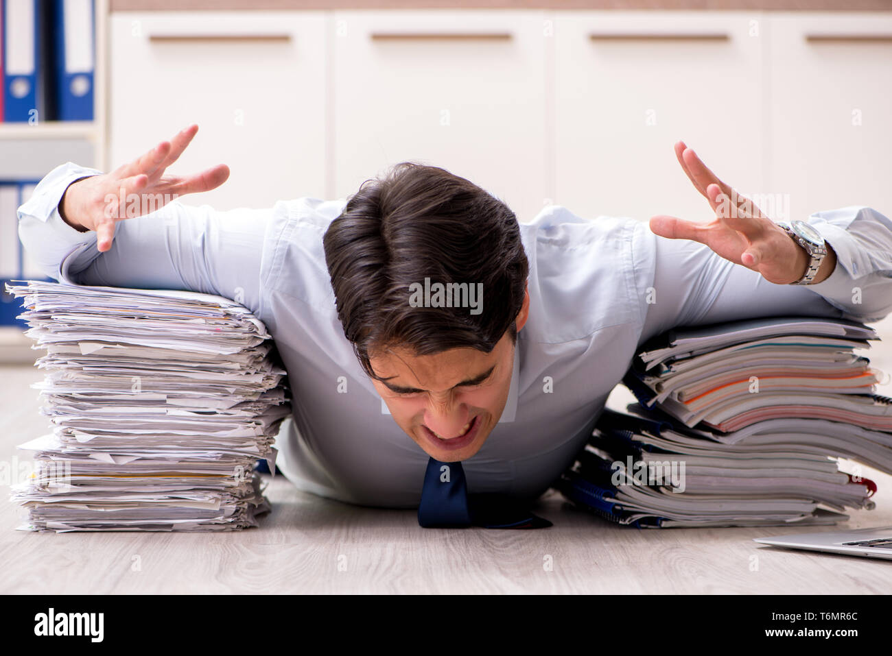 Extremely busy employee working in the office Stock Photo - Alamy
