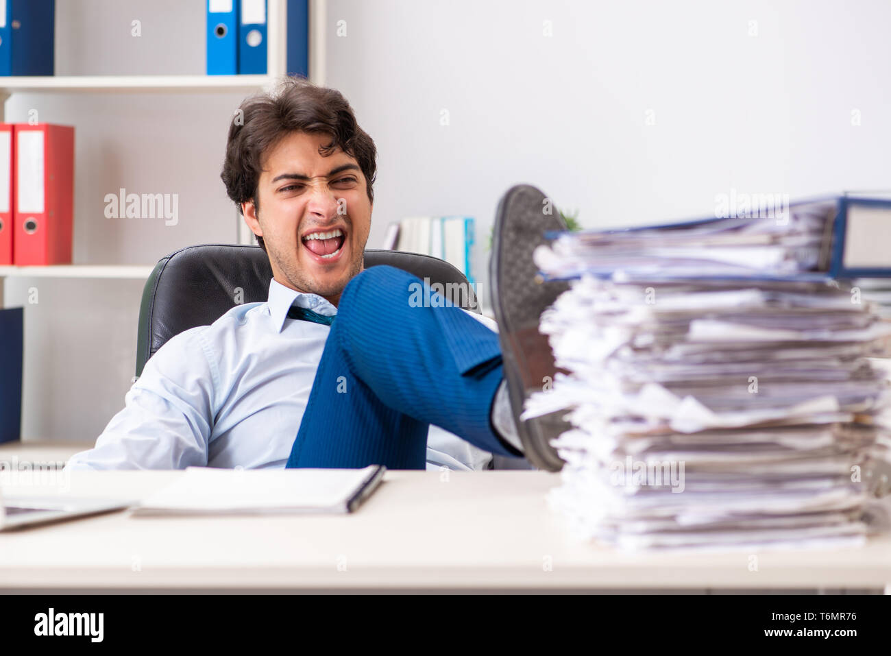 Overloaded busy employee with too much work and paperwork Stock Photo ...