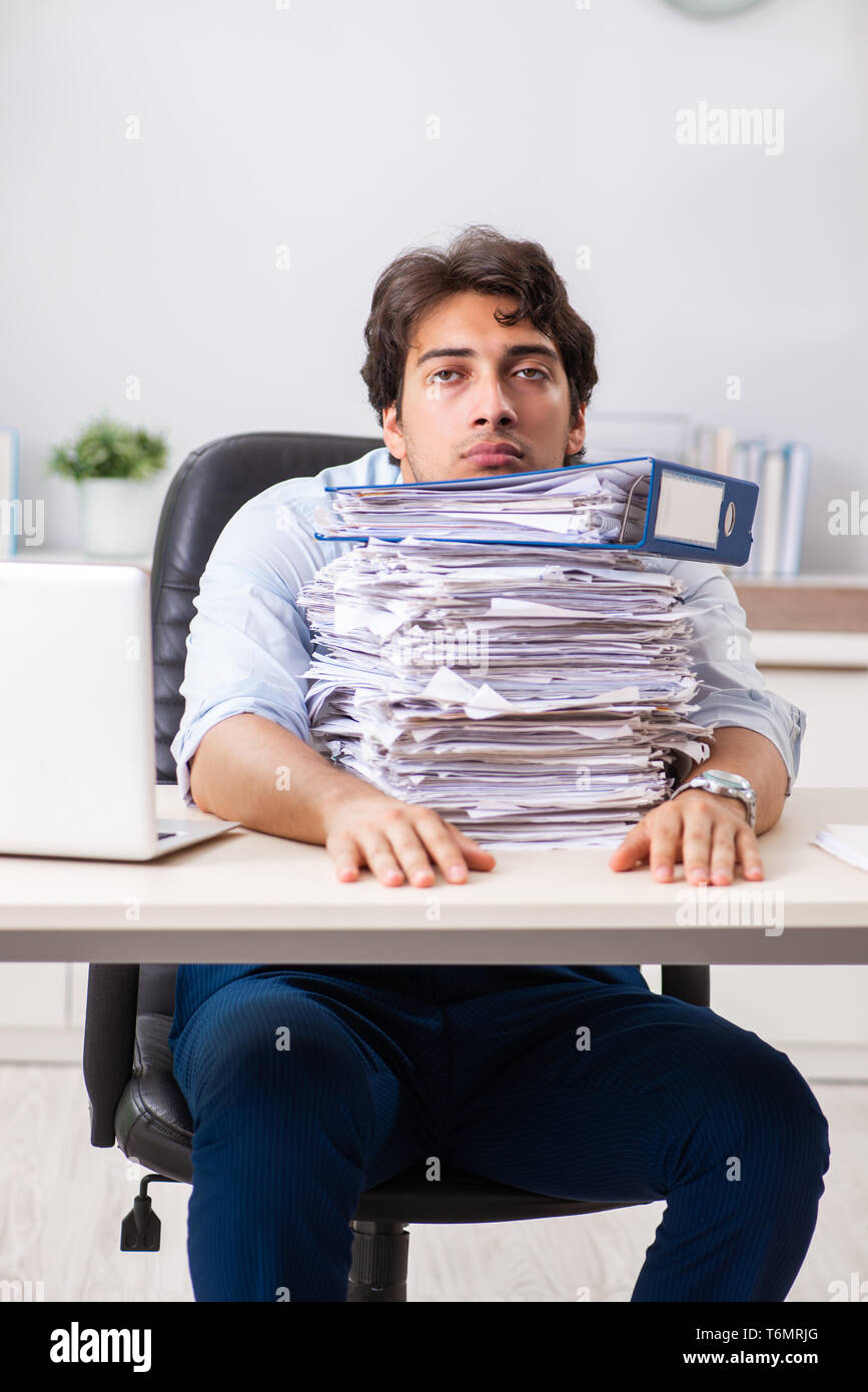 Overloaded busy employee with too much work and paperwork Stock Photo ...