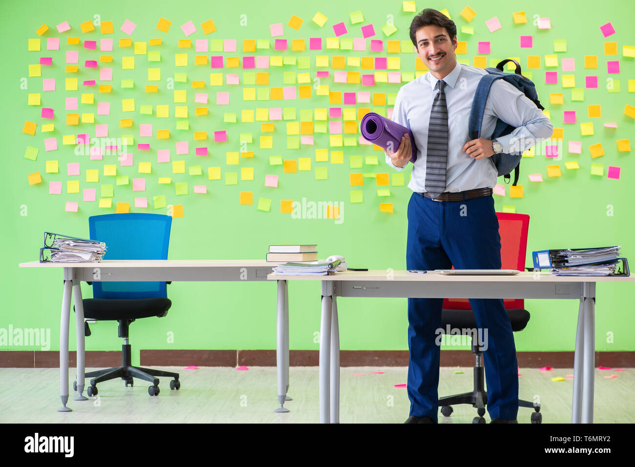 Man in the office with many conflicting priorities preparing go Stock ...