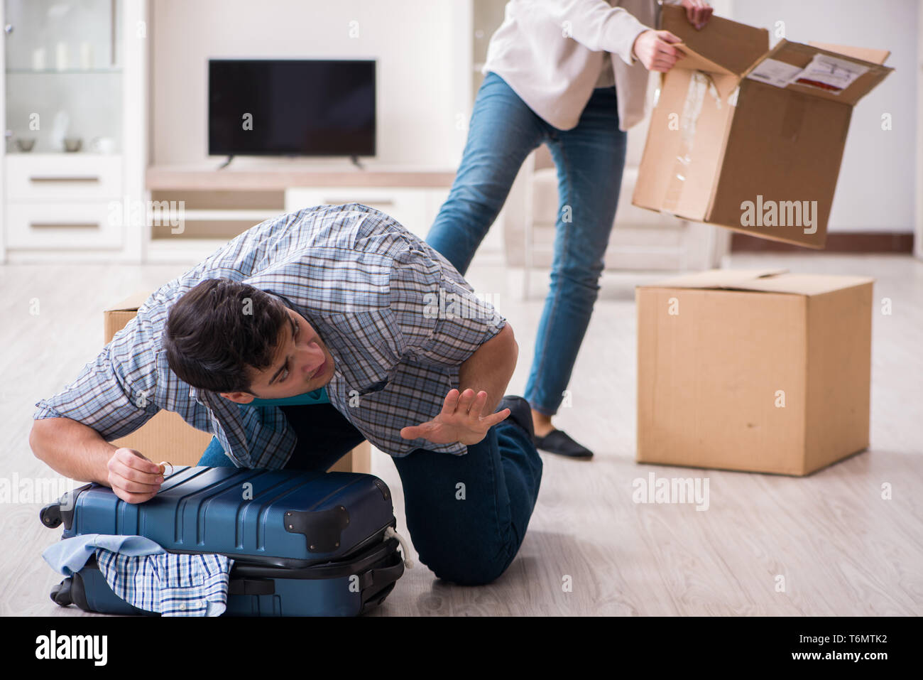 Woman evicting man from house during family conflict Stock Photo - Alamy