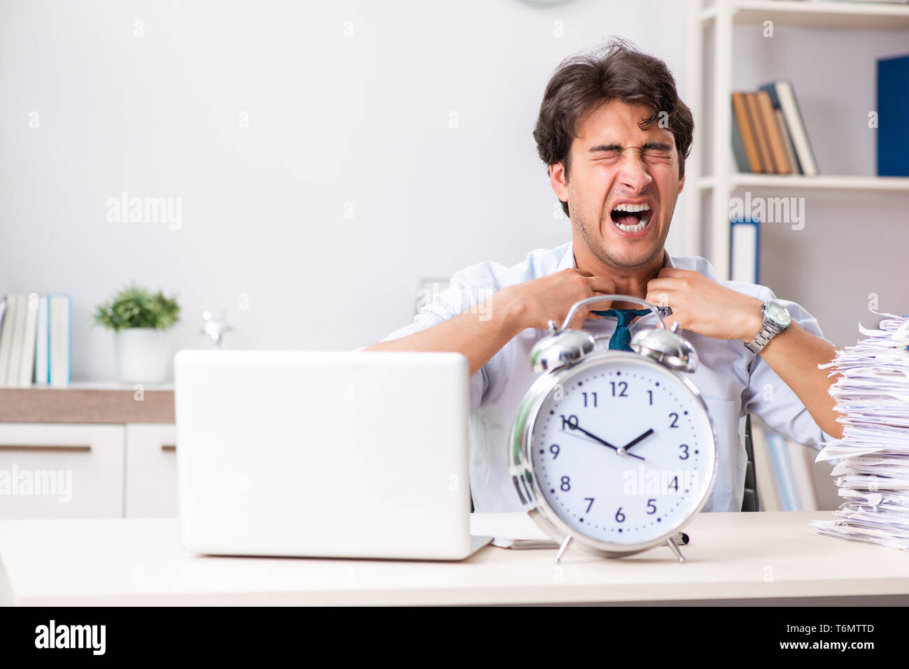 Overloaded busy employee with too much work and paperwork Stock Photo ...