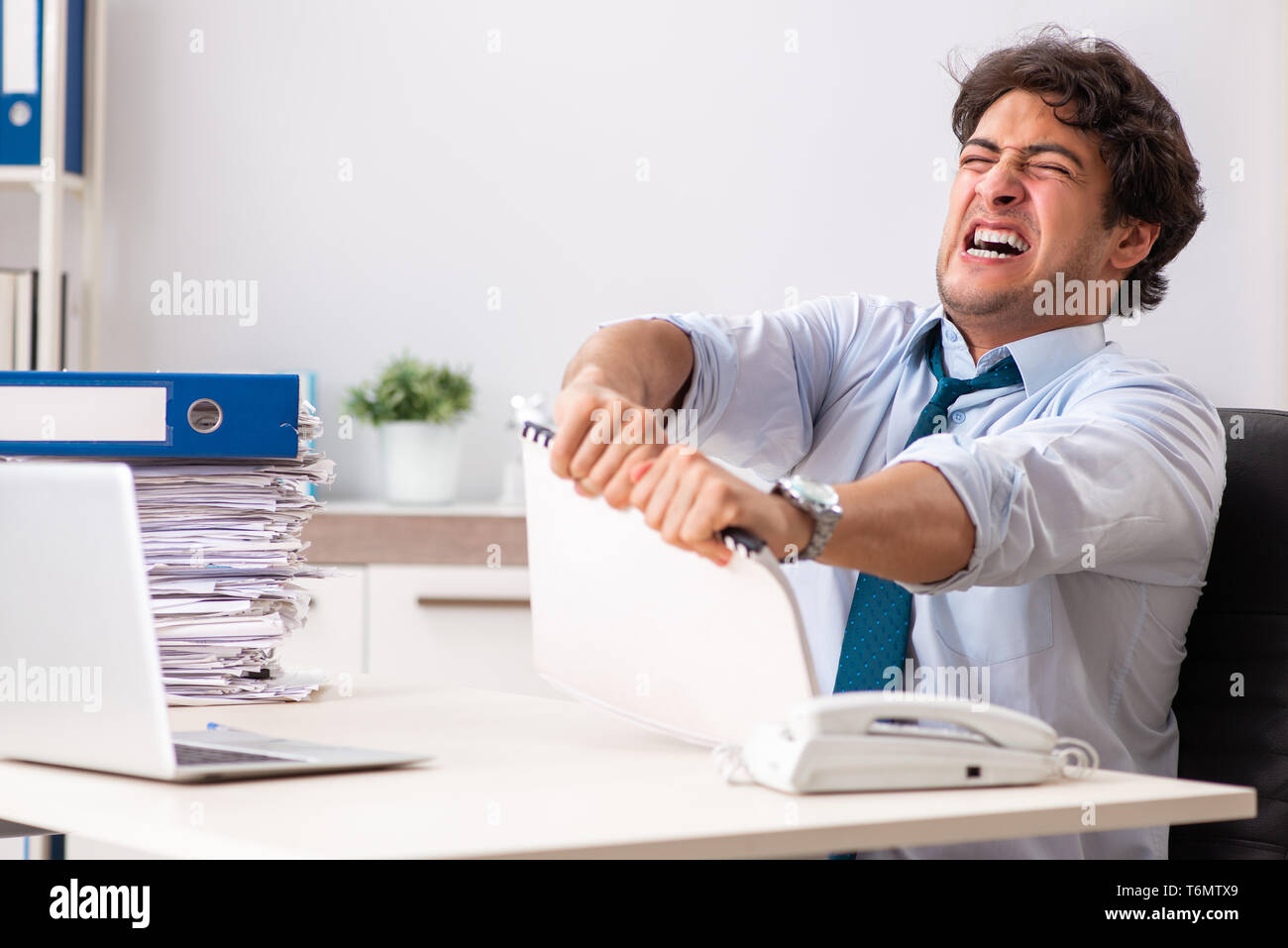 Overloaded busy employee with too much work and paperwork Stock Photo ...