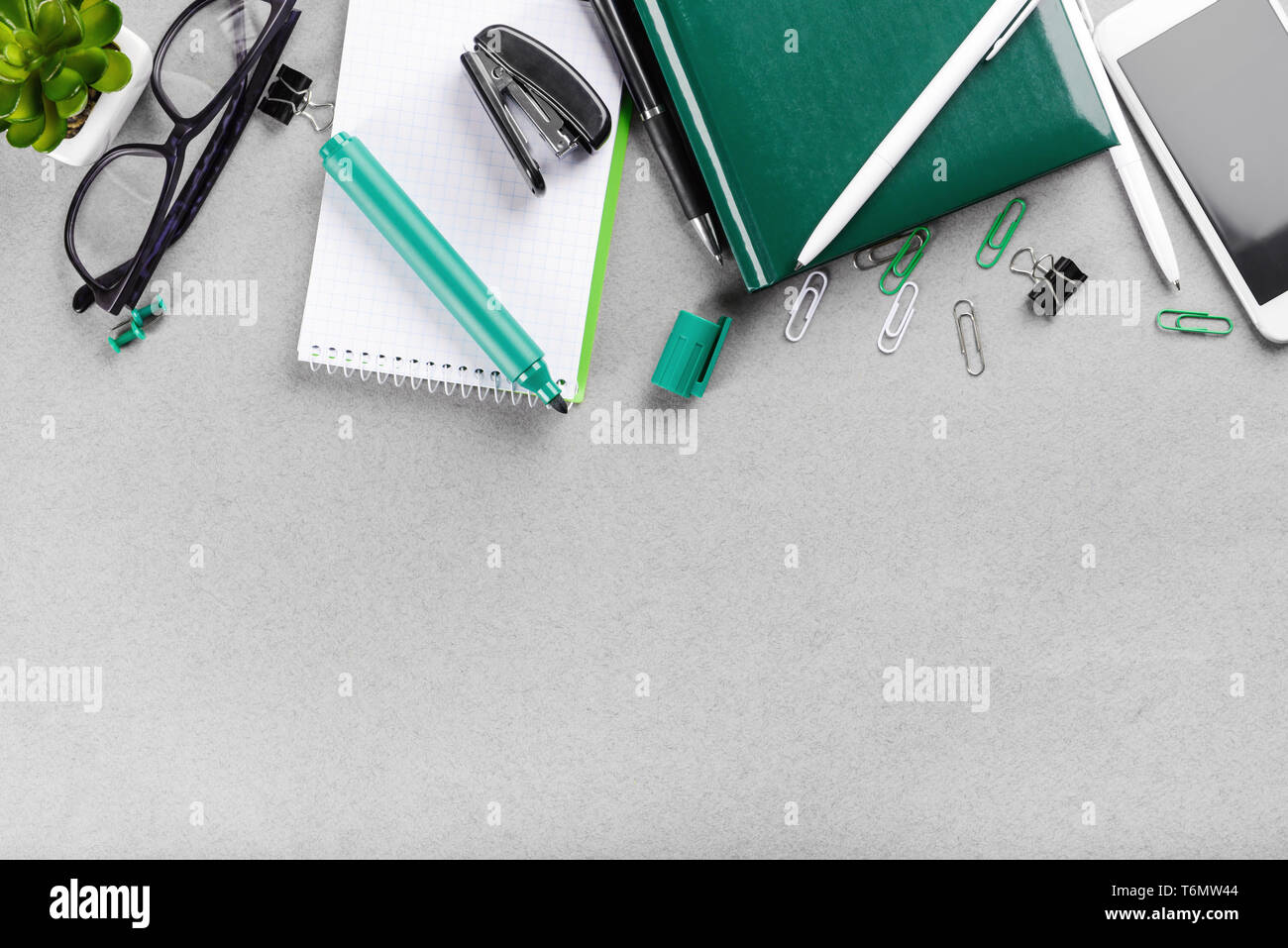 Workplace with stationery and phone on table. Top view Stock Photo - Alamy