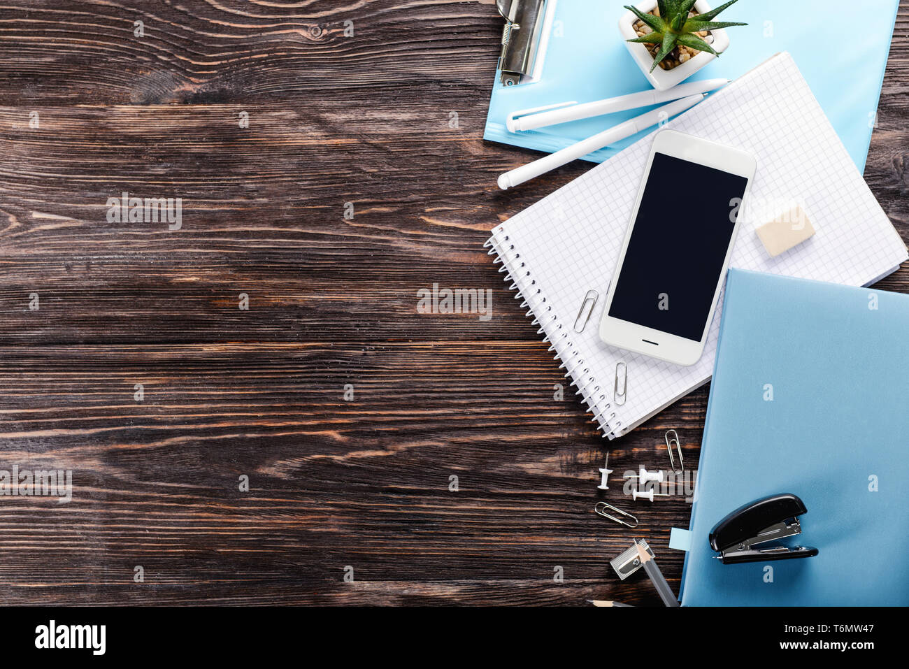 Workplace with stationery and phone on table. Top view Stock Photo - Alamy