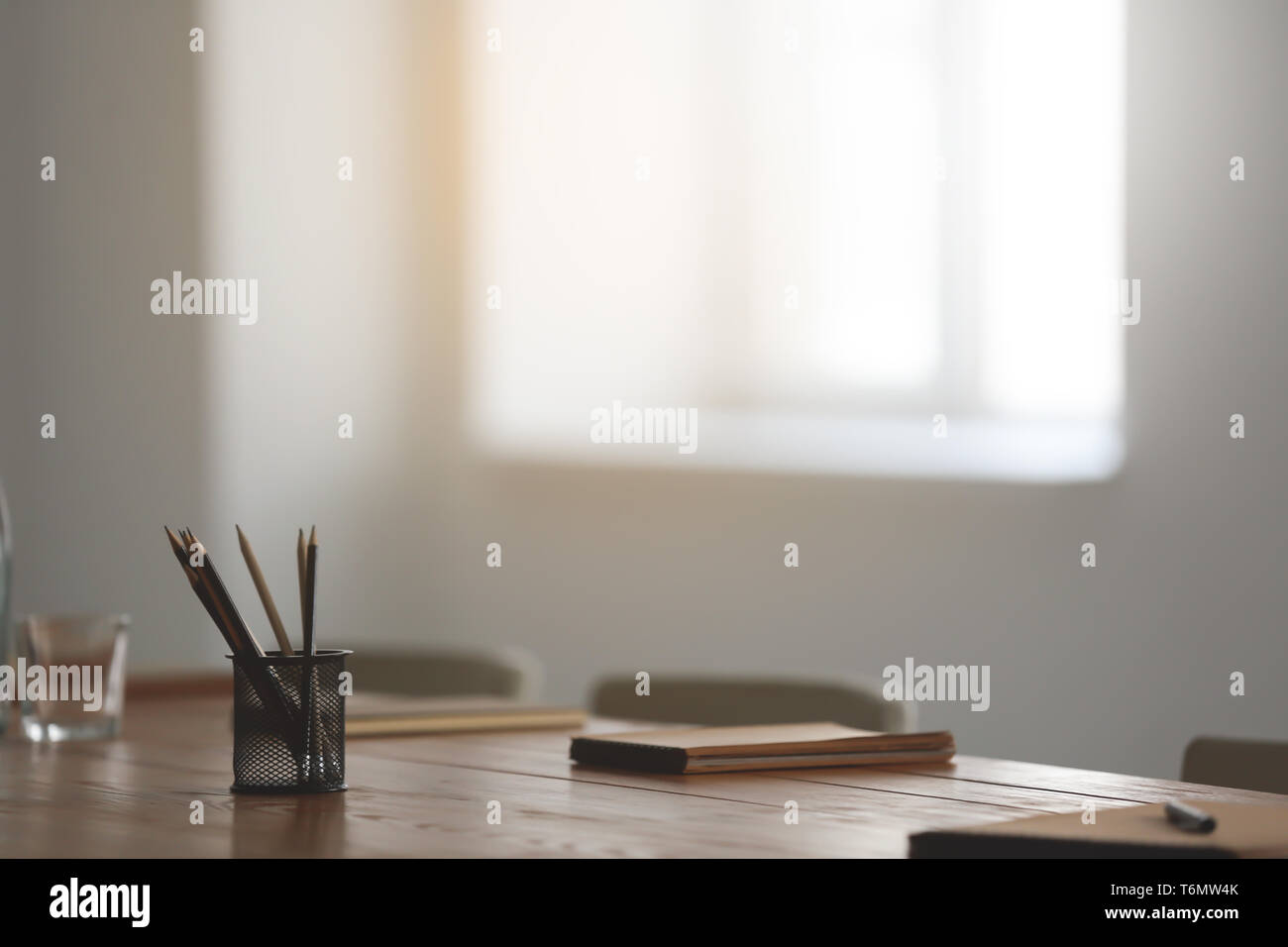 Table with notebooks and stationery prepared for business meeting in ...