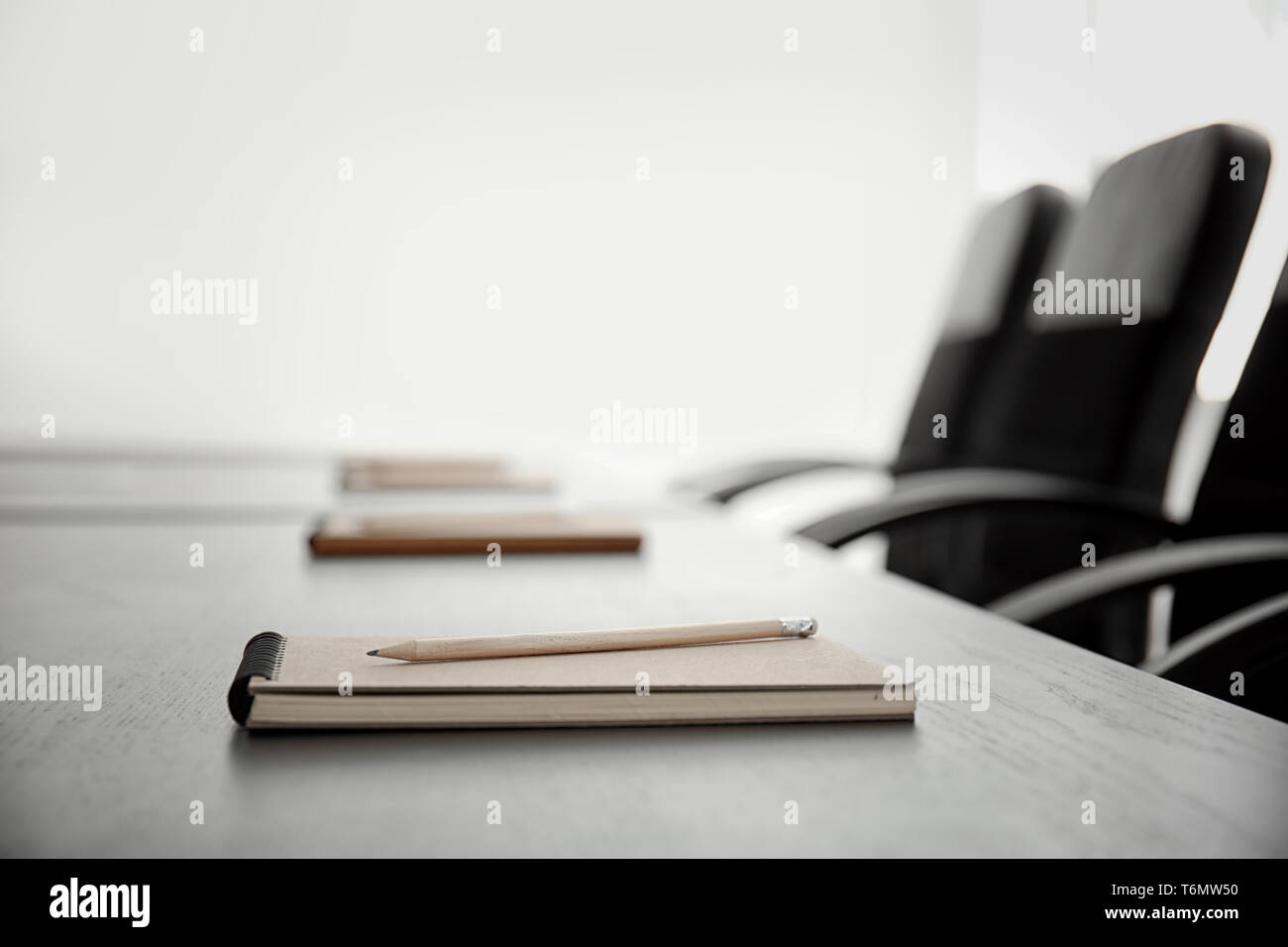 Table with notebooks prepared for business meeting in conference hall ...