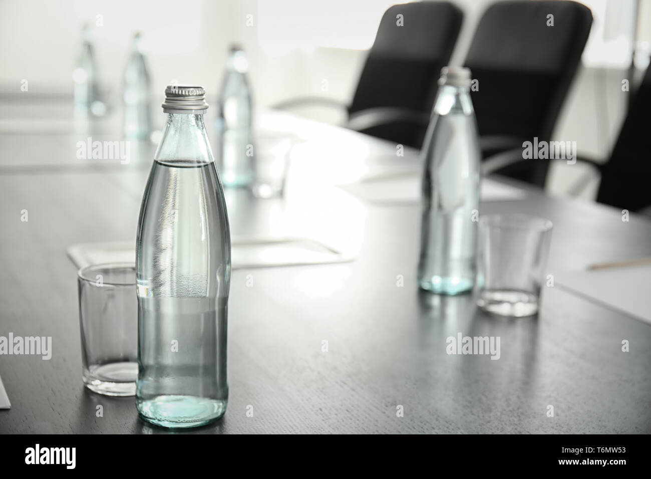 Table with bottle of water prepared for business meeting in conference ...
