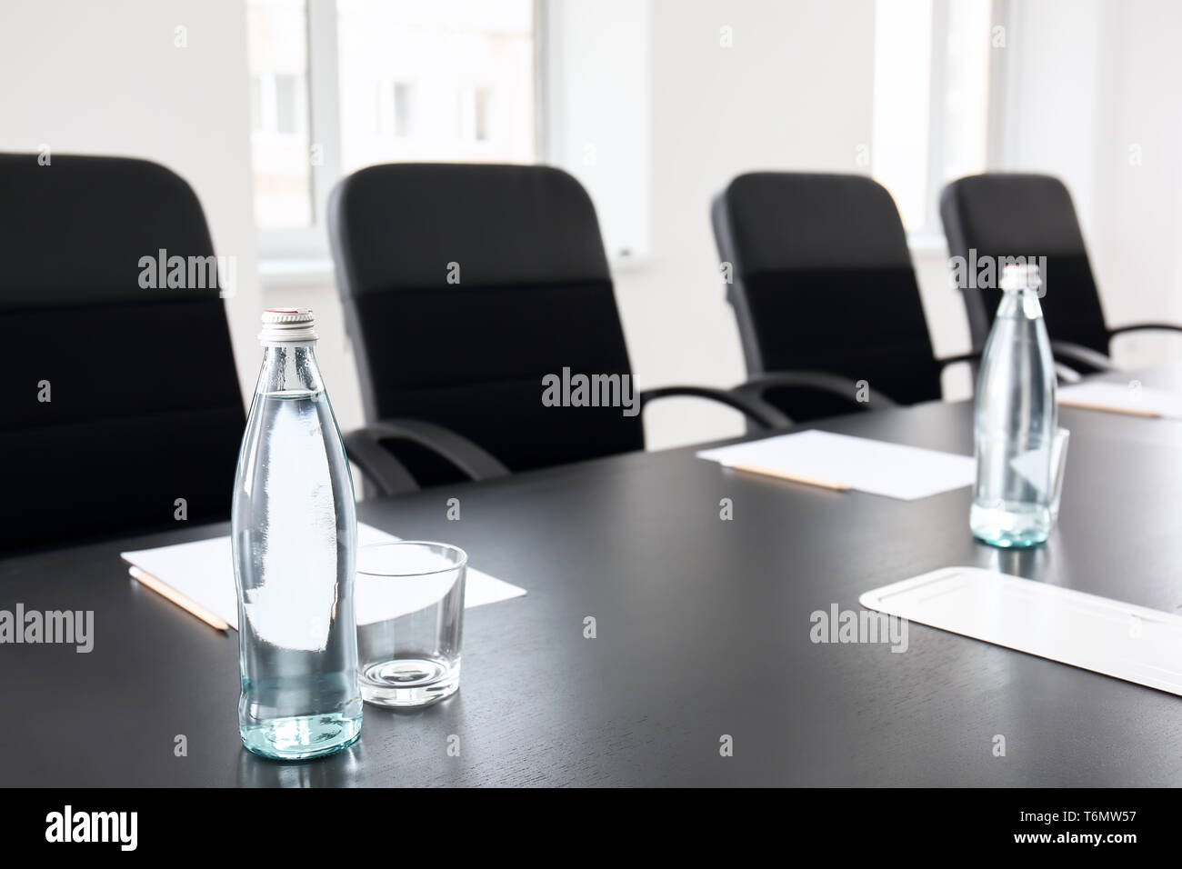 Table with bottles of water prepared for business meeting in conference ...