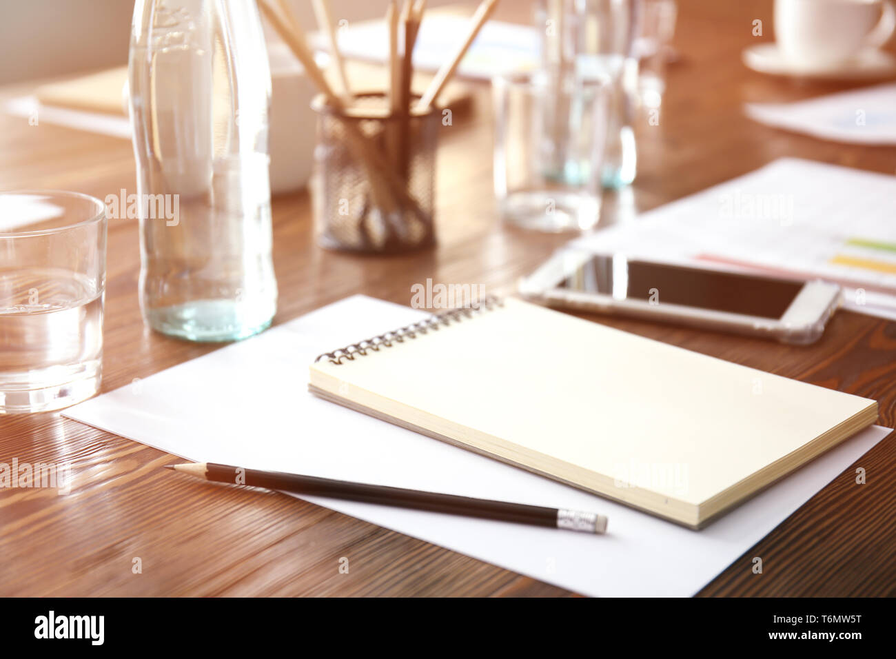 Table with notebook prepared for business meeting in conference hall ...