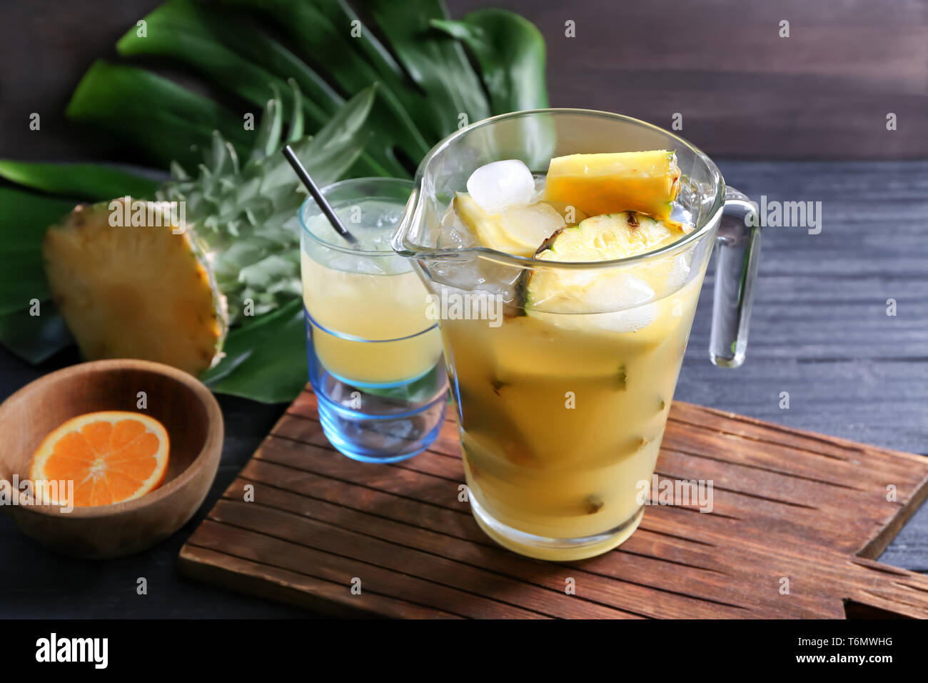 Glass jug with tasty fresh pineapple juice on table Stock Photo - Alamy