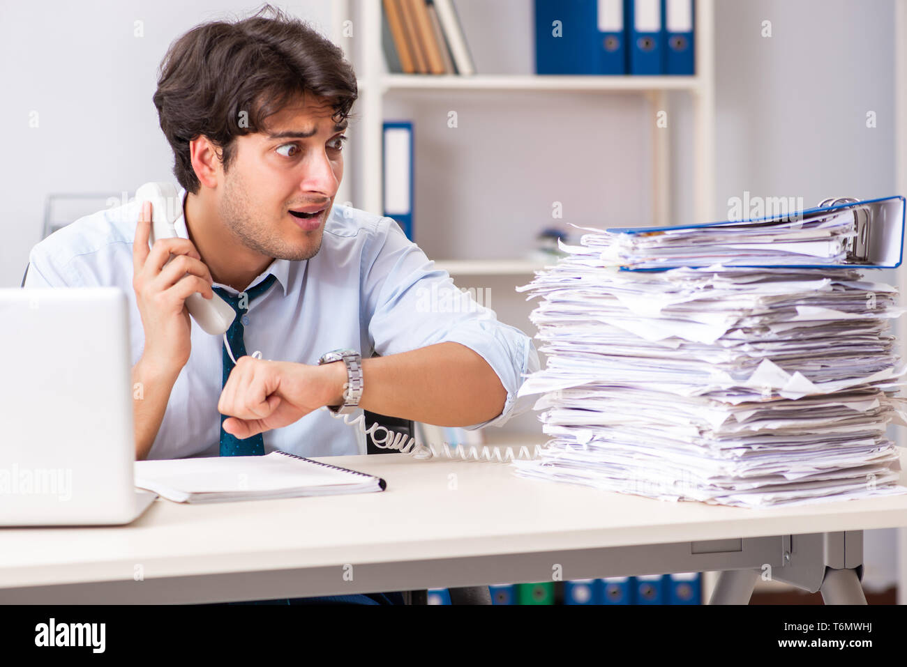Overloaded busy employee with too much work and paperwork Stock Photo ...