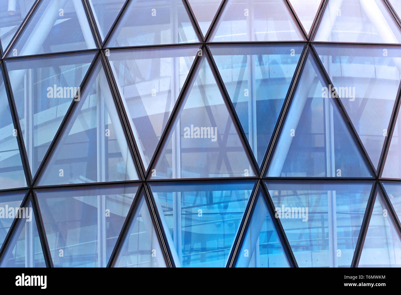 Blue glass triangular windows at office building Stock Photo - Alamy
