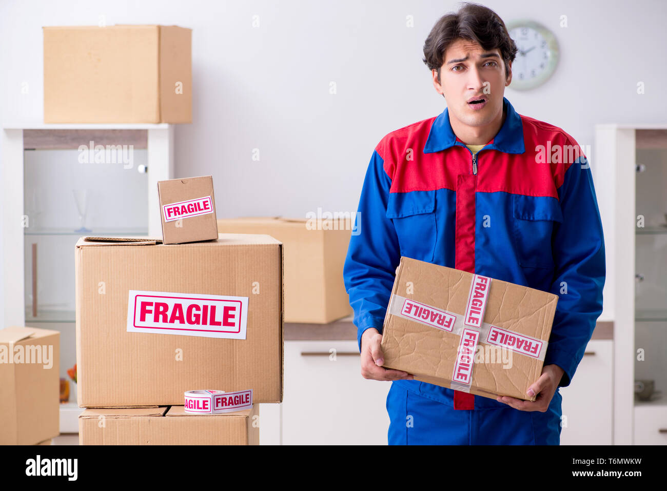 Transportation contractor with fragile boxes Stock Photo - Alamy