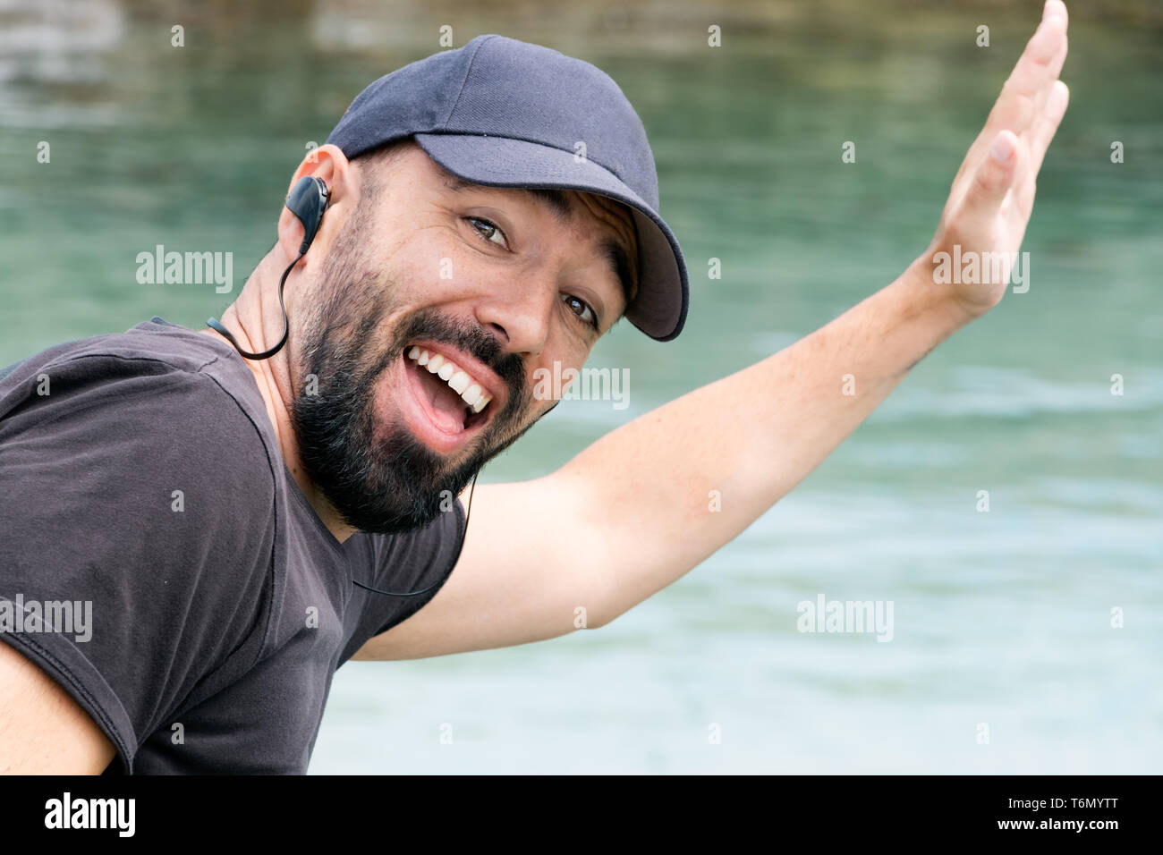 Portrait Of A Spanish Man With Beard Casual Style Using A Wireless portrait-of-a-spanish-man-with-beard-casual-style-using-a-wireless