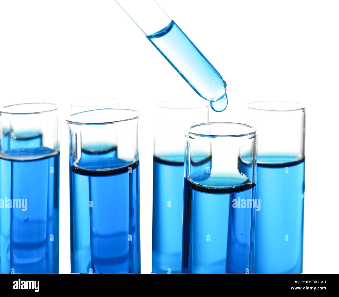 Dripping blue liquid into test tubes on white background Stock Photo ...