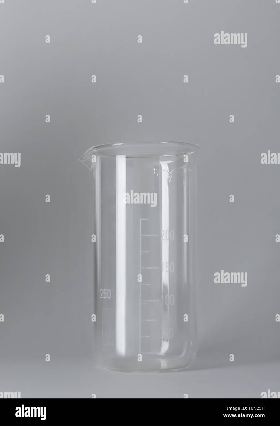 Glass beaker on light background Stock Photo - Alamy