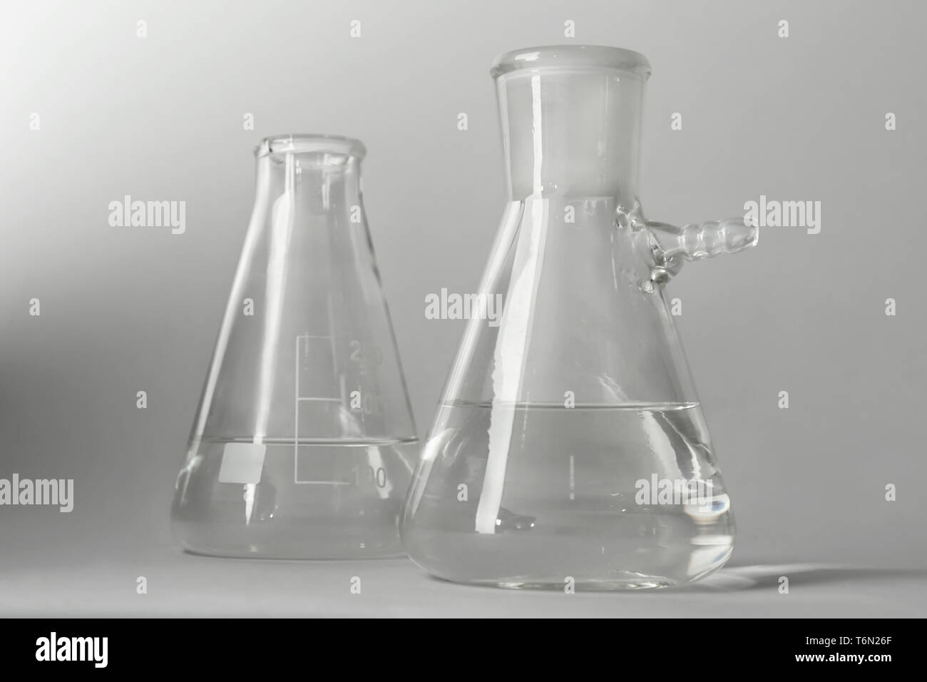 Test flasks with water on light background Stock Photo - Alamy