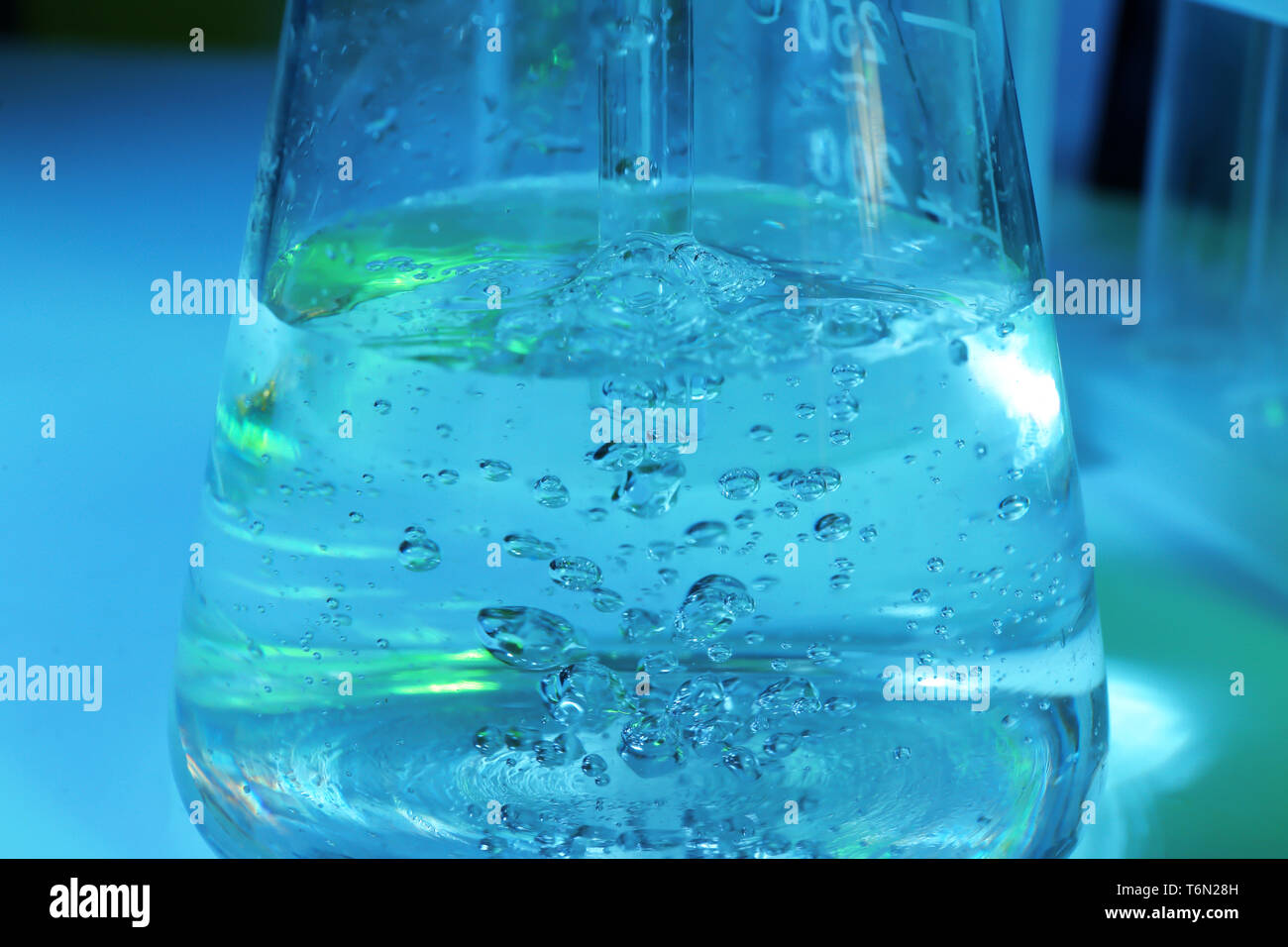 Test flask with water on color background, closeup Stock Photo - Alamy