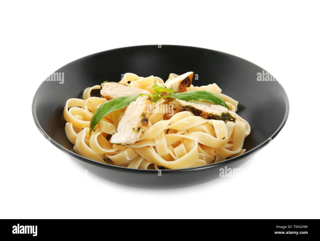 Plate of delicious pasta with chicken fillet on white background Stock ...