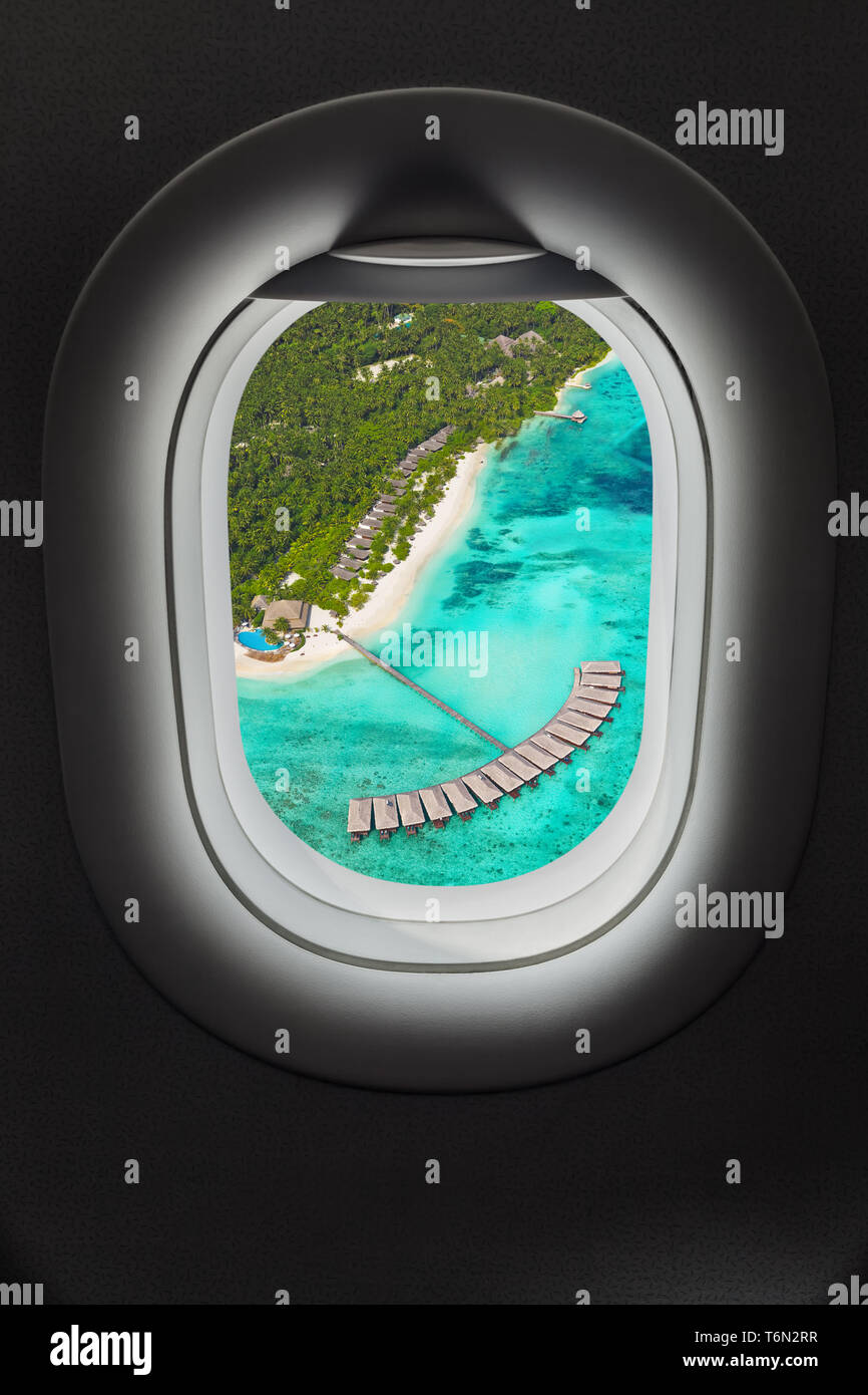 Tropical island at Maldives in airplane window Stock Photo - Alamy