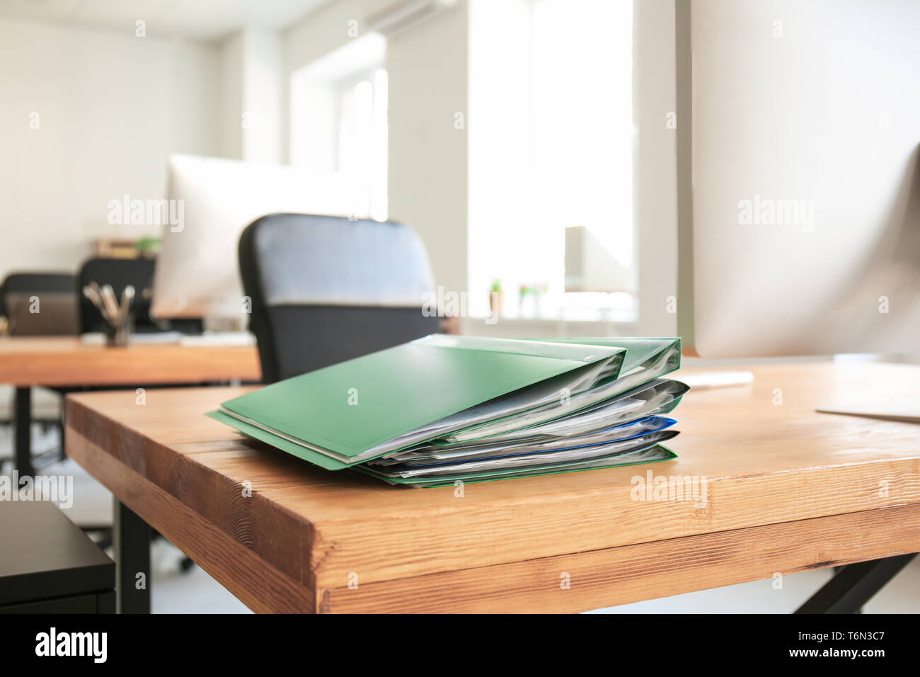 Workplace with computer and folders on table in modern office Stock ...