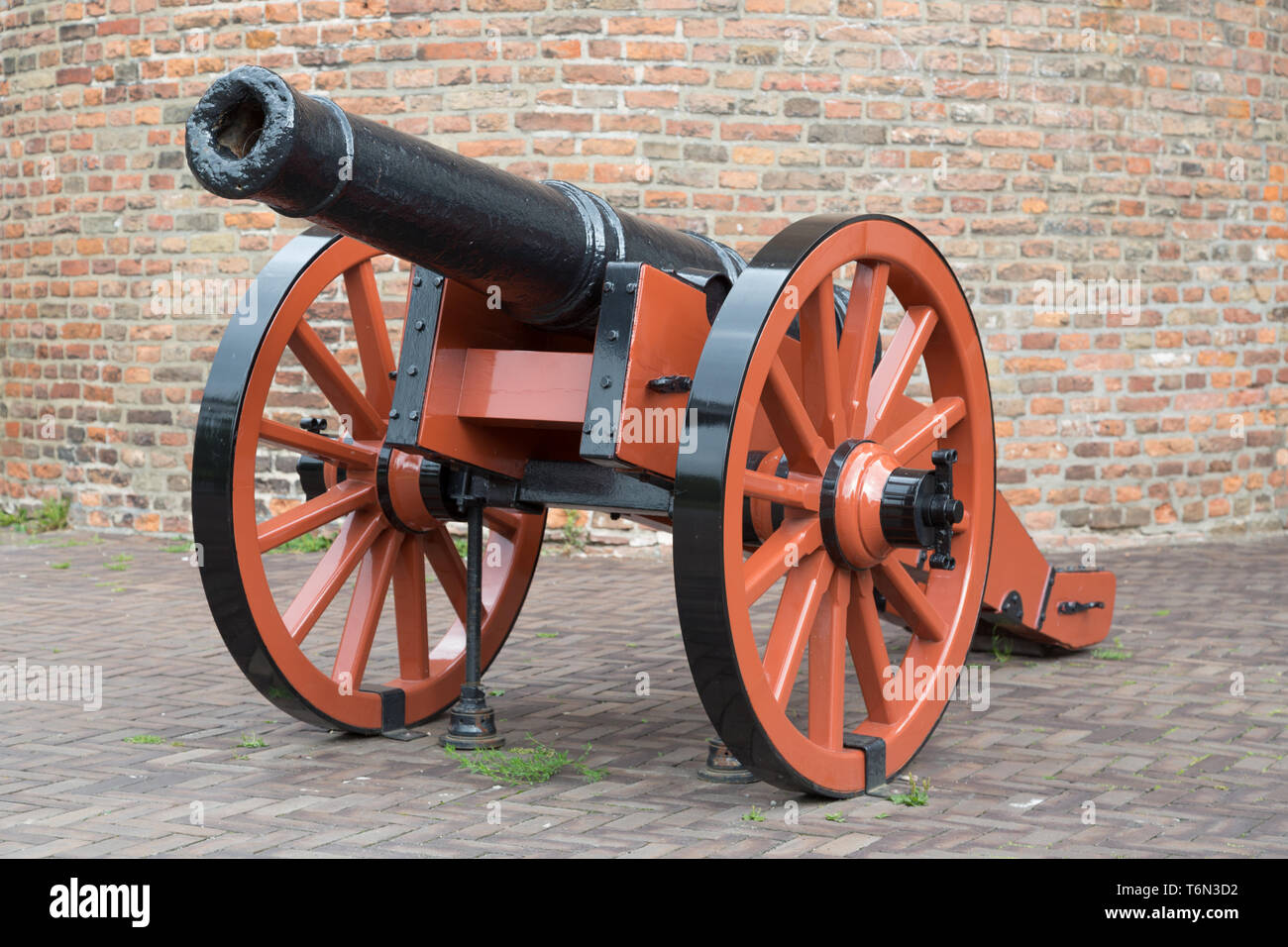 Old medieval artillery canon before a brick wall Stock Photo - Alamy