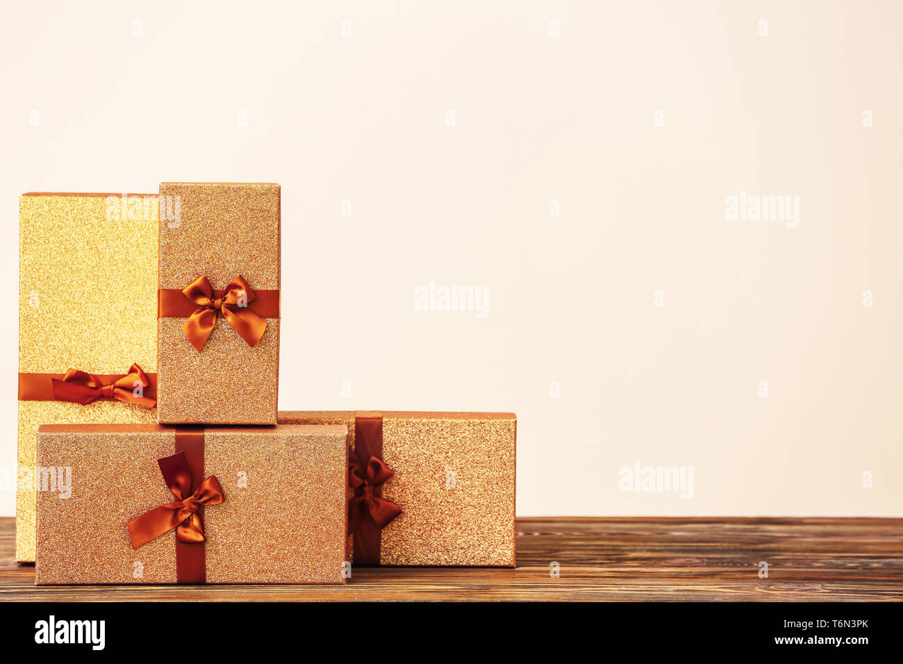 Elegant gift boxes on table against light background Stock Photo - Alamy