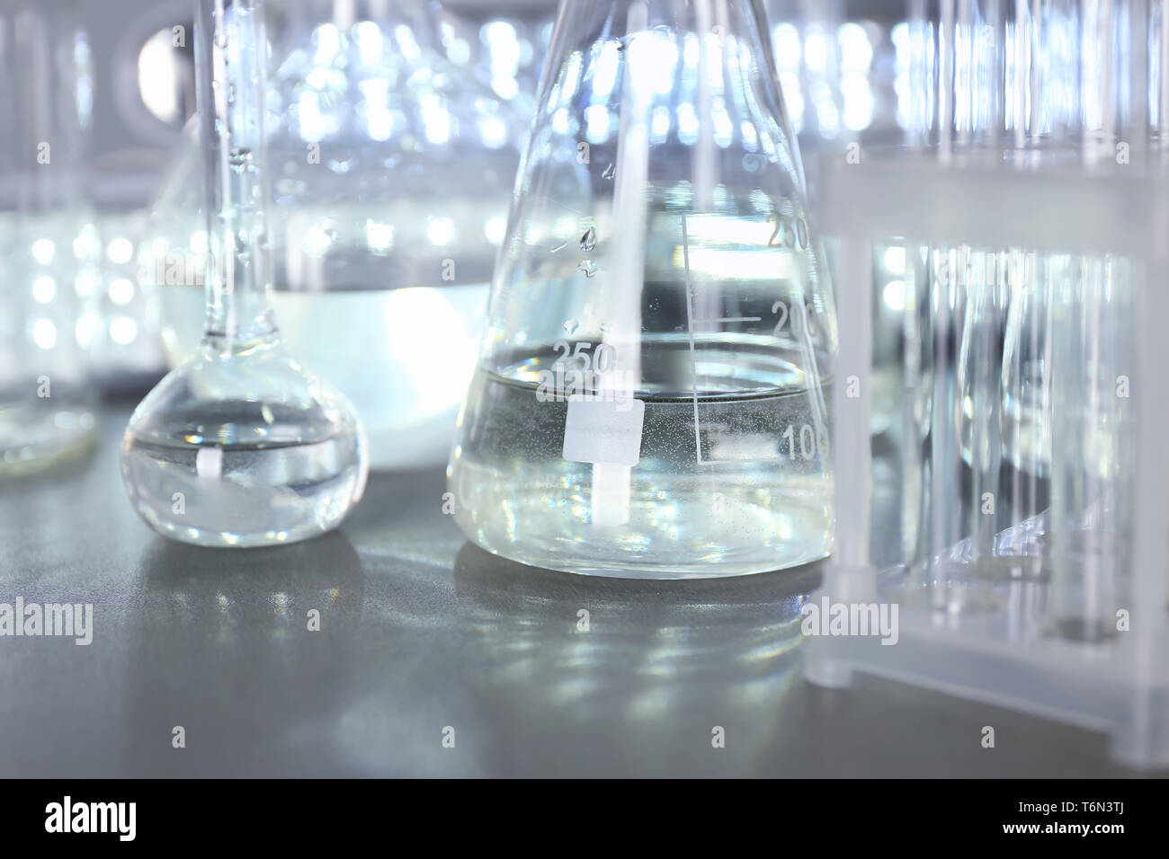 Test tubes and flasks with water on table Stock Photo - Alamy