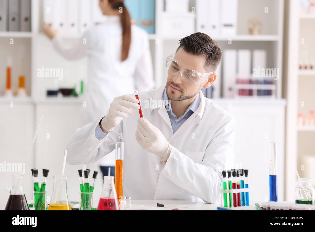 Scientist holding test tube with color sample in laboratory Stock Photo ...