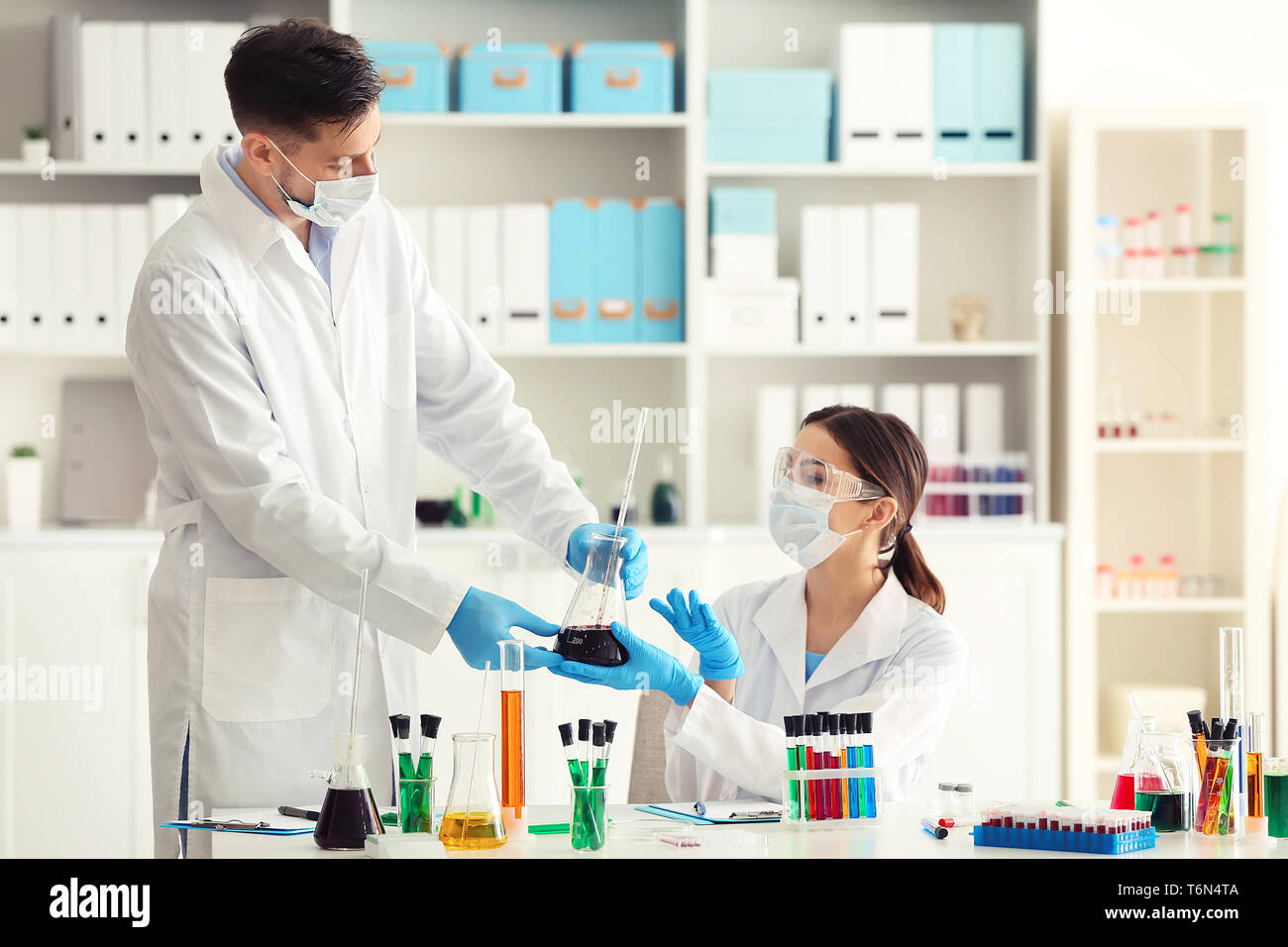 Man glasses pipette biochemistry mask hi-res stock photography and ...