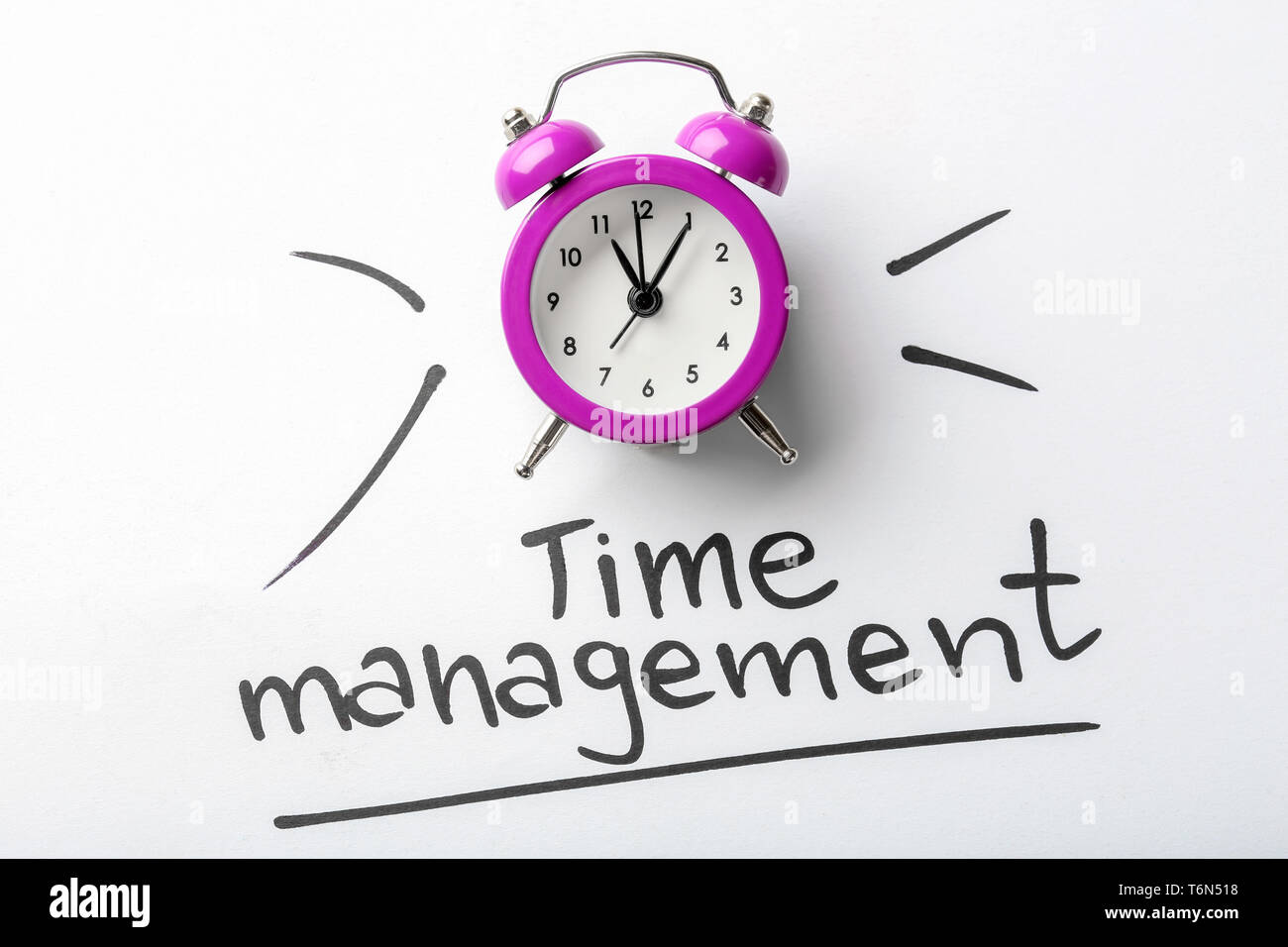 Alarm clock and phrase TIME MANAGEMENT on white background, top view ...